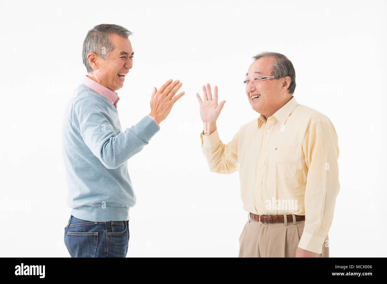 Two senior men high fiving Stock Photo - Alamy