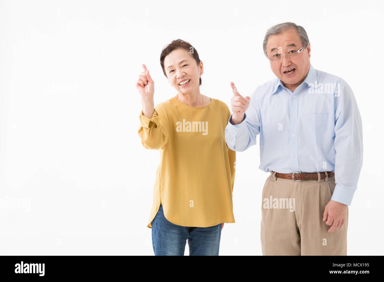 Senior couple pointing Stock Photo - Alamy