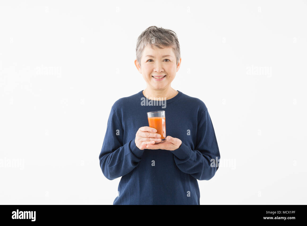 Senior woman having juice Stock Photo - Alamy