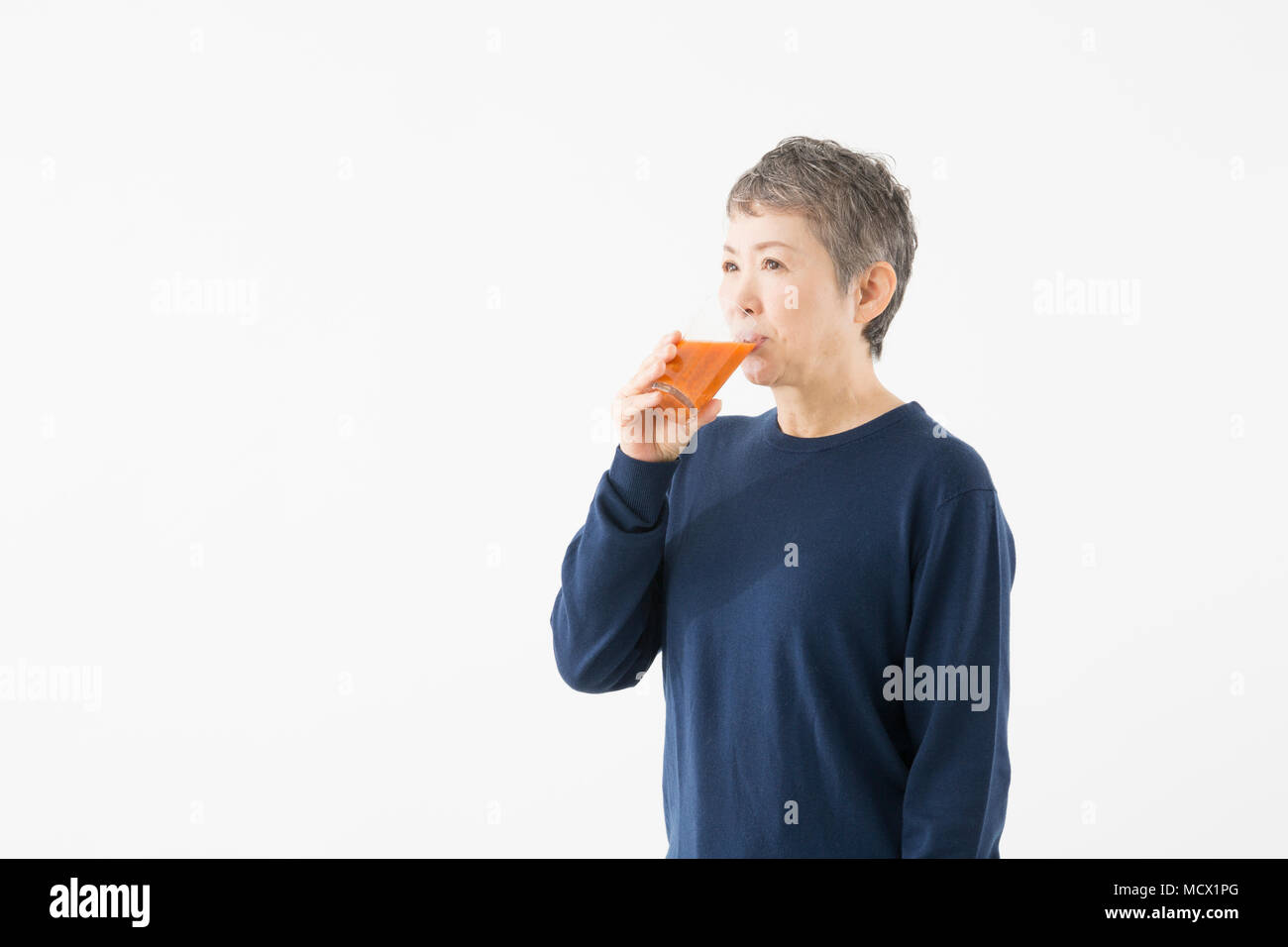 Woman elderly drinking juice hi-res stock photography and images - Alamy