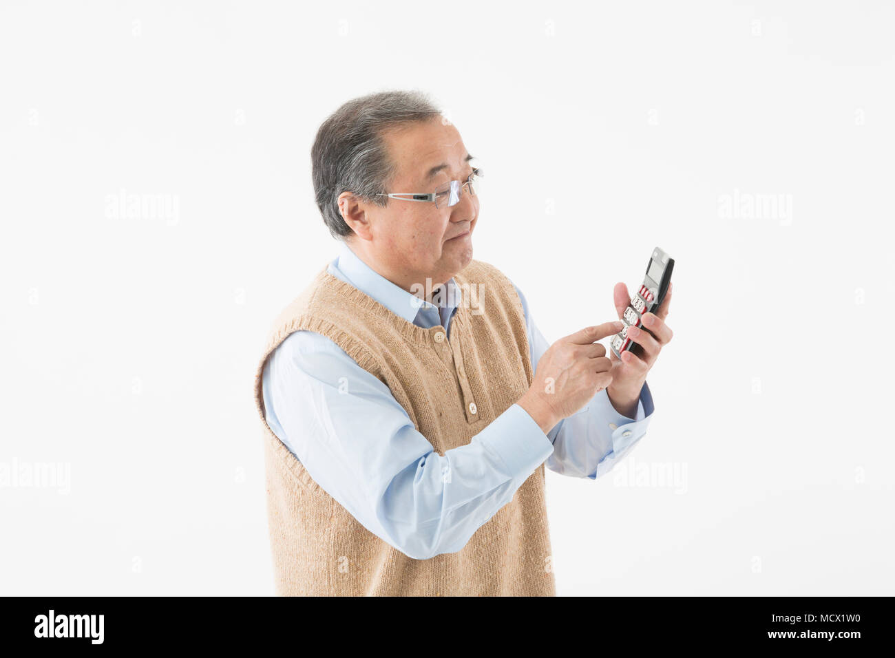 Senior man calculating Stock Photo - Alamy