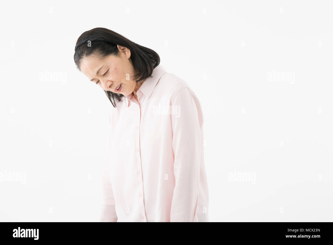 Senior woman with head down Stock Photo - Alamy