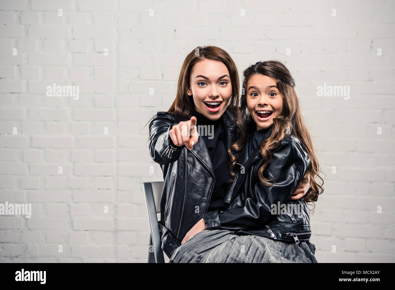 beautiful Mother pointing on something to surprised daughter Stock ...