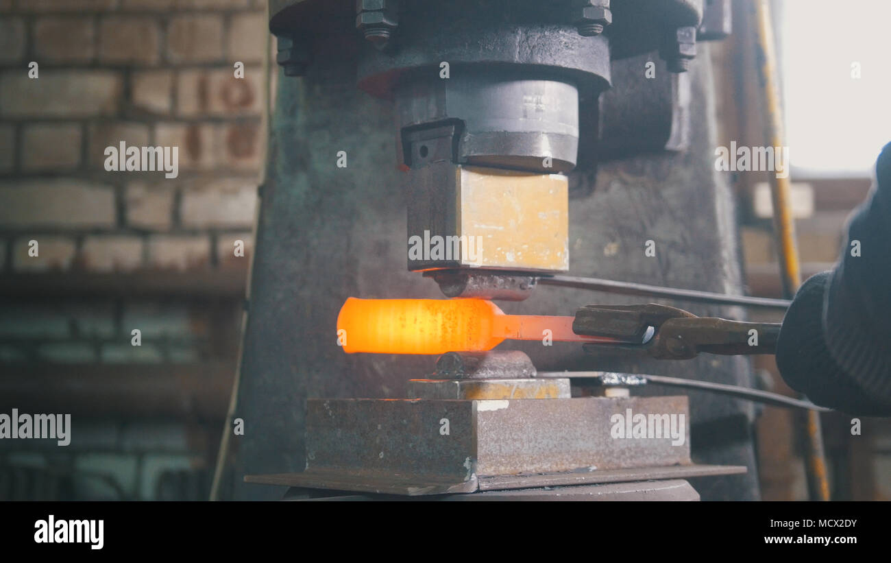 Blacksmith with hammer in forge creating steel knife Stock Photo - Alamy