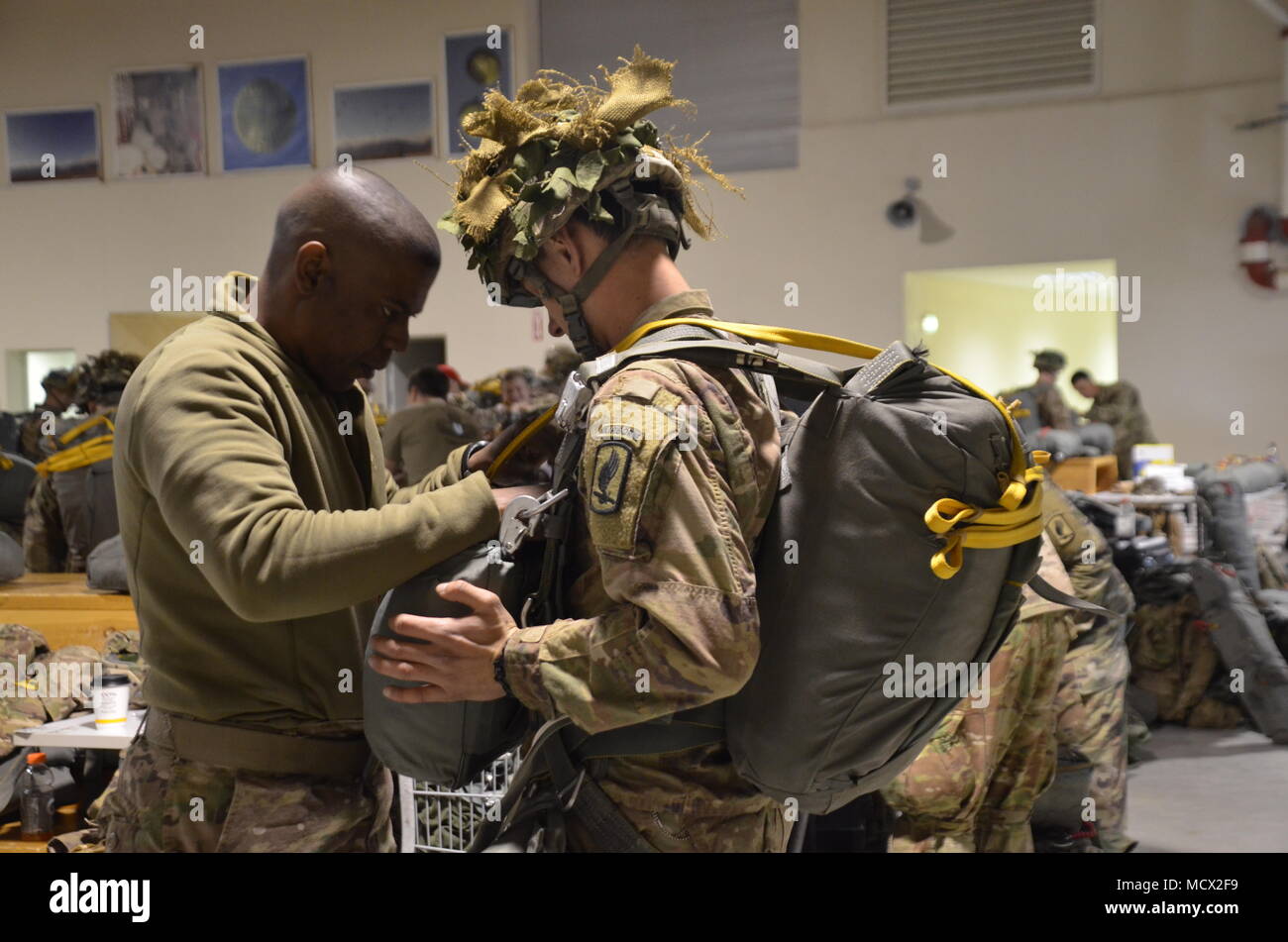 A jumpmaster inspects the rigging of a 173rd Airborne Brigade ...