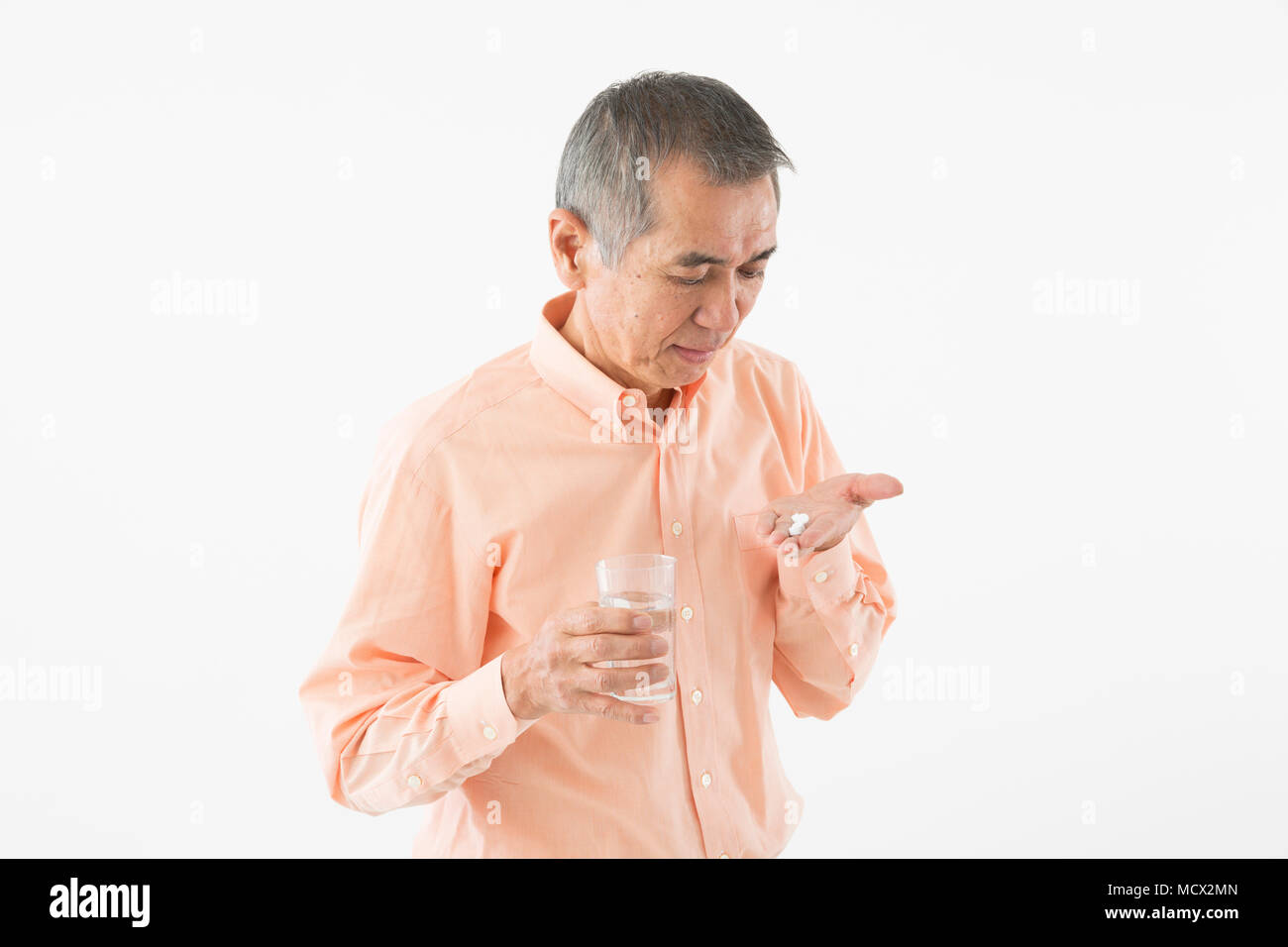 Senior man taking medicine Stock Photo - Alamy