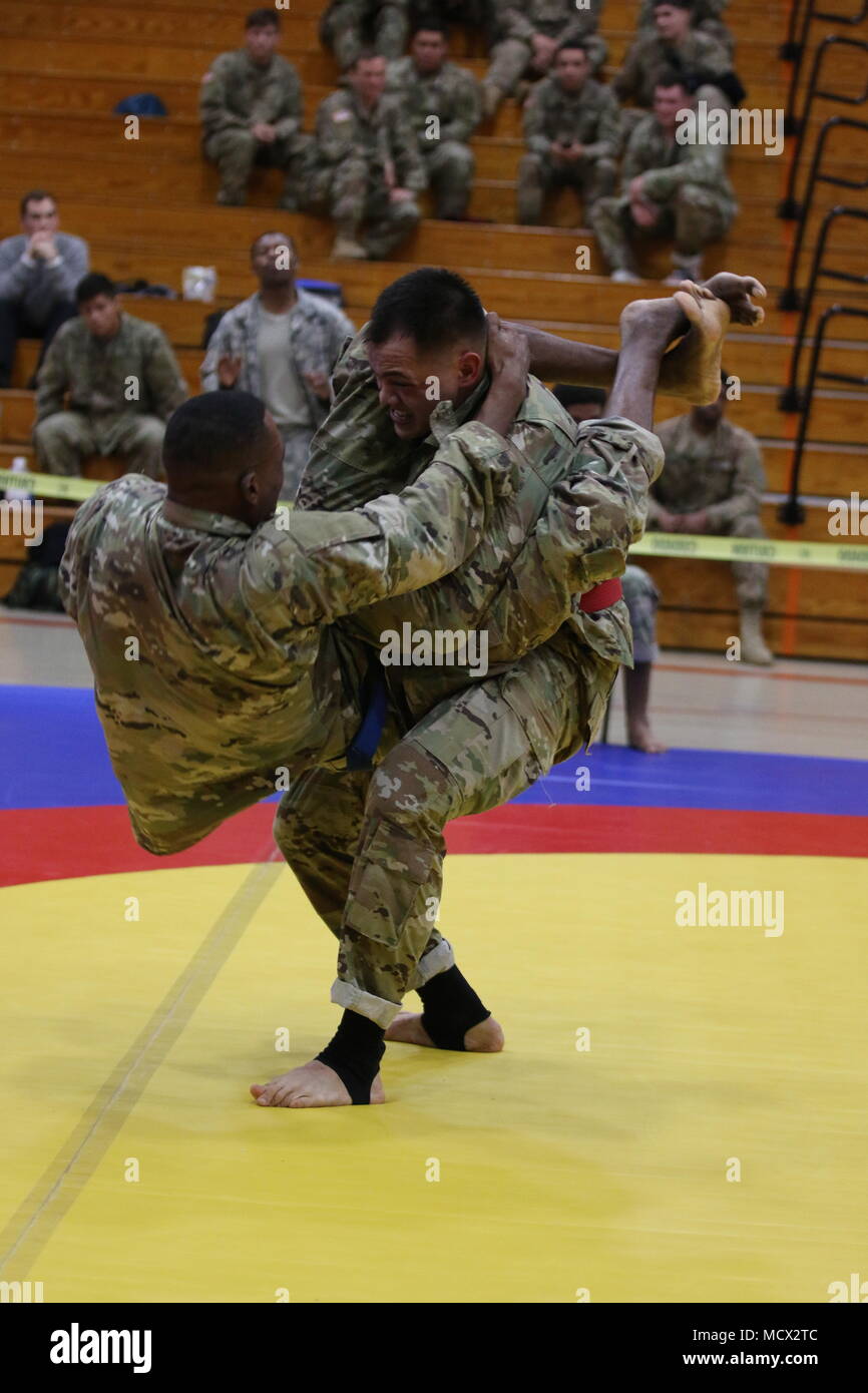 A service member attempts to escape his opponent’s hold during the ...