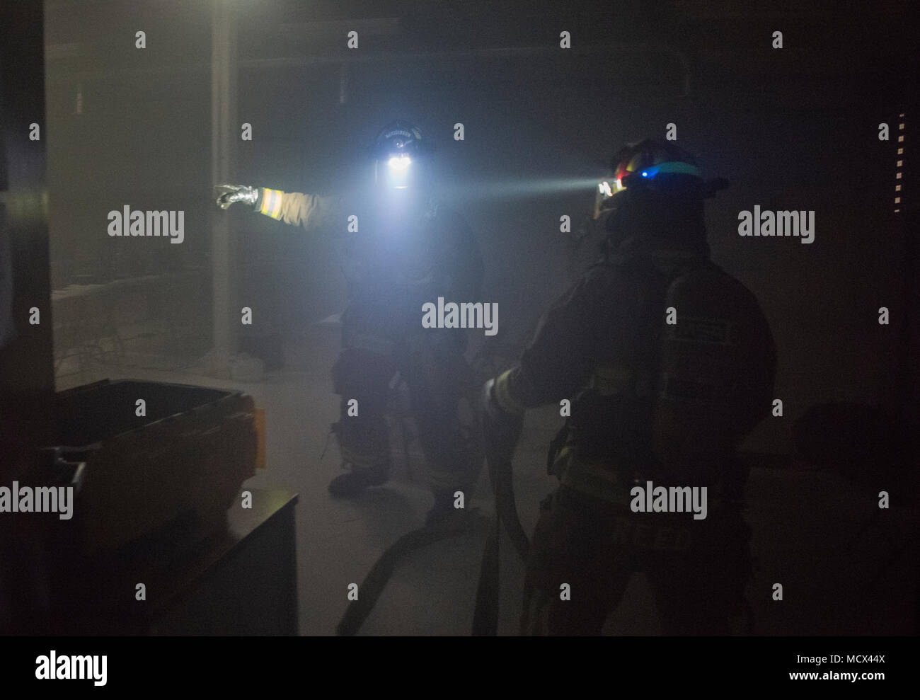 Fire fighters with the 60th Civil Engineer Squadron respond to an ...