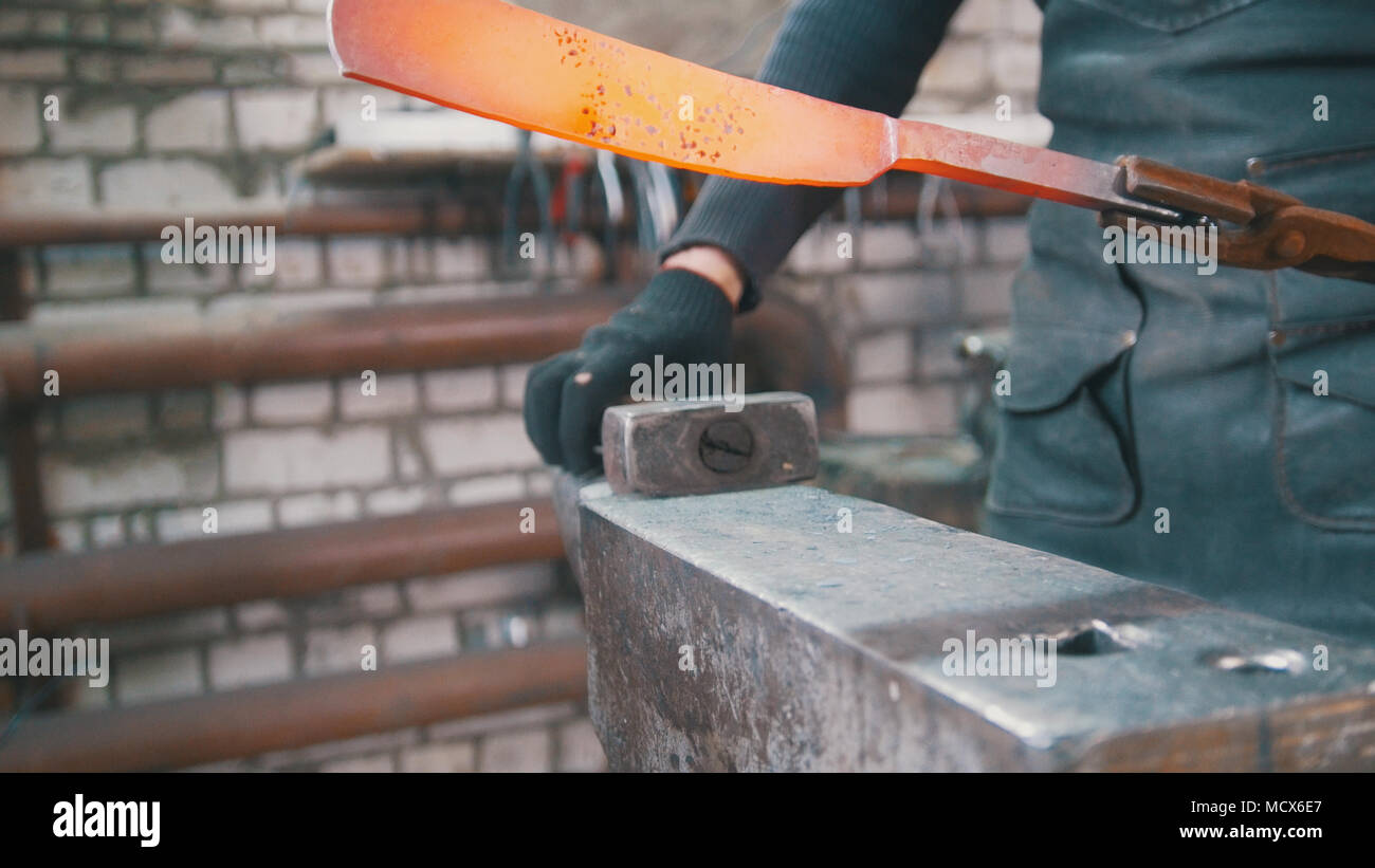 Muscular blacksmith in forge near metal anvil Stock Photo - Alamy