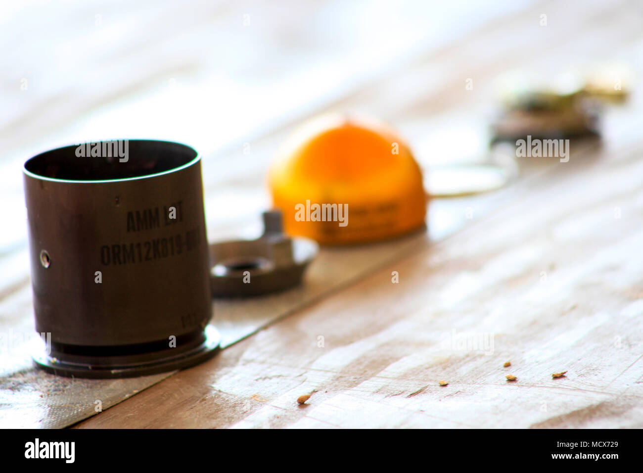 A 40 mm grenade sits disassembled during explosive ordnance disposal ...