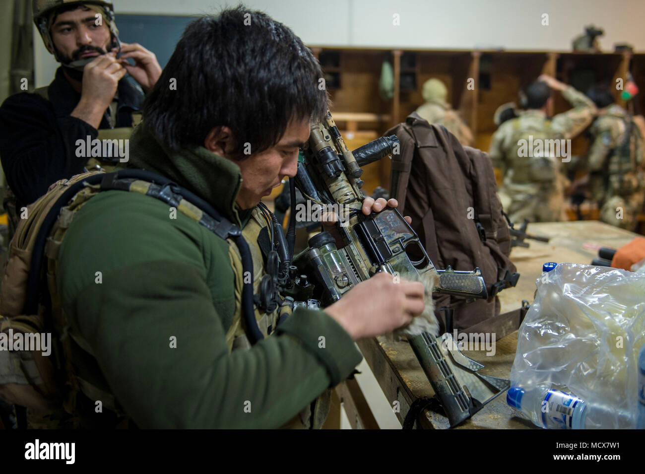 An Afghan National Mission Brigade special operator prepares his M4 ...