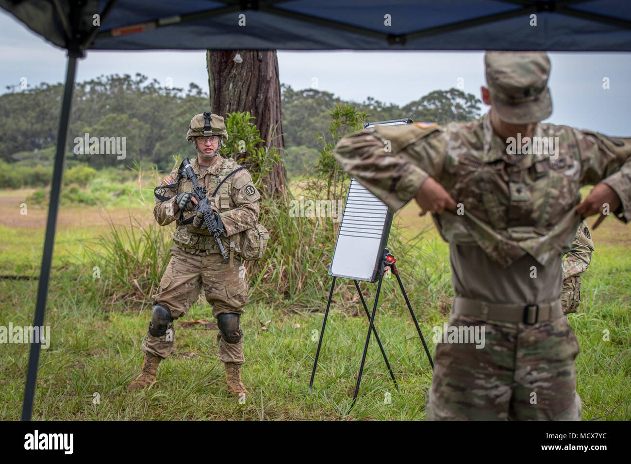Sgt. Jeffrey O. Embry of the 411th Engineer Battalion searches a ...