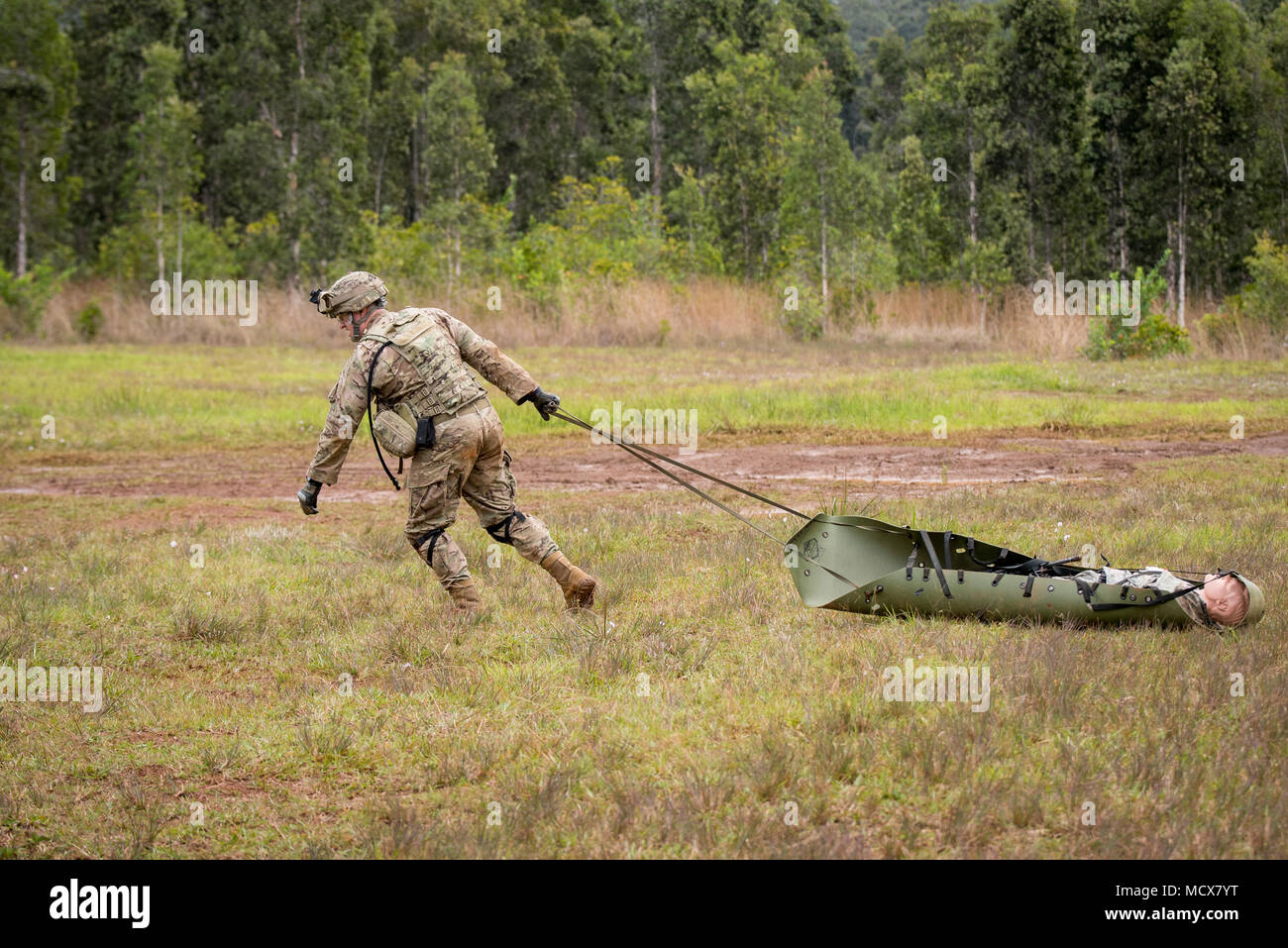 Sgt. Jeffrey O. Embry of the 411th Engineer Battalion drags the ...