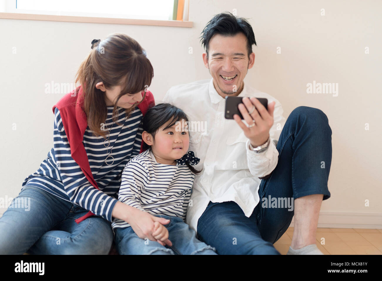 Three close parents and child Stock Photo - Alamy