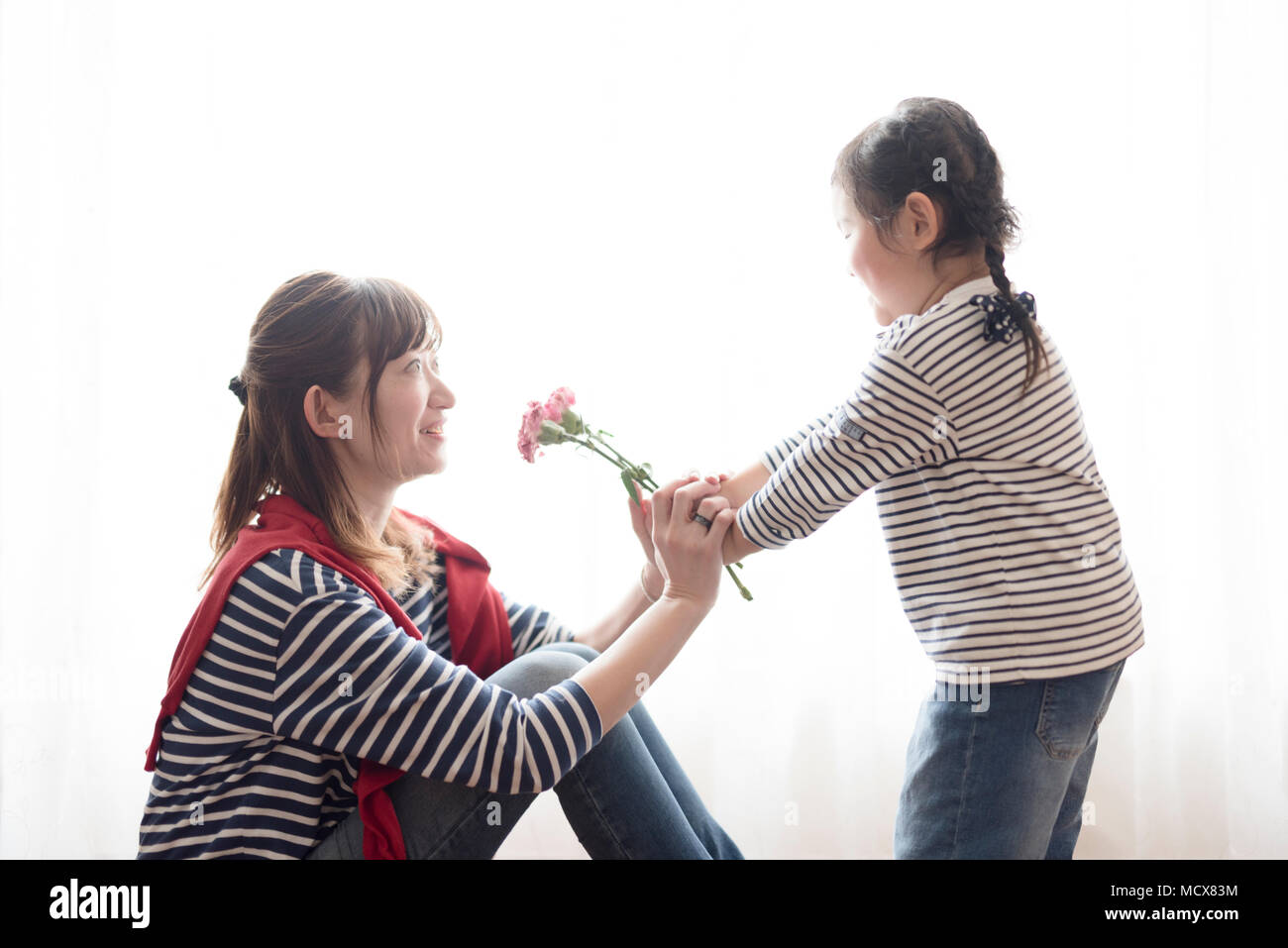 Child giving flowers to adult hi-res stock photography and images - Alamy