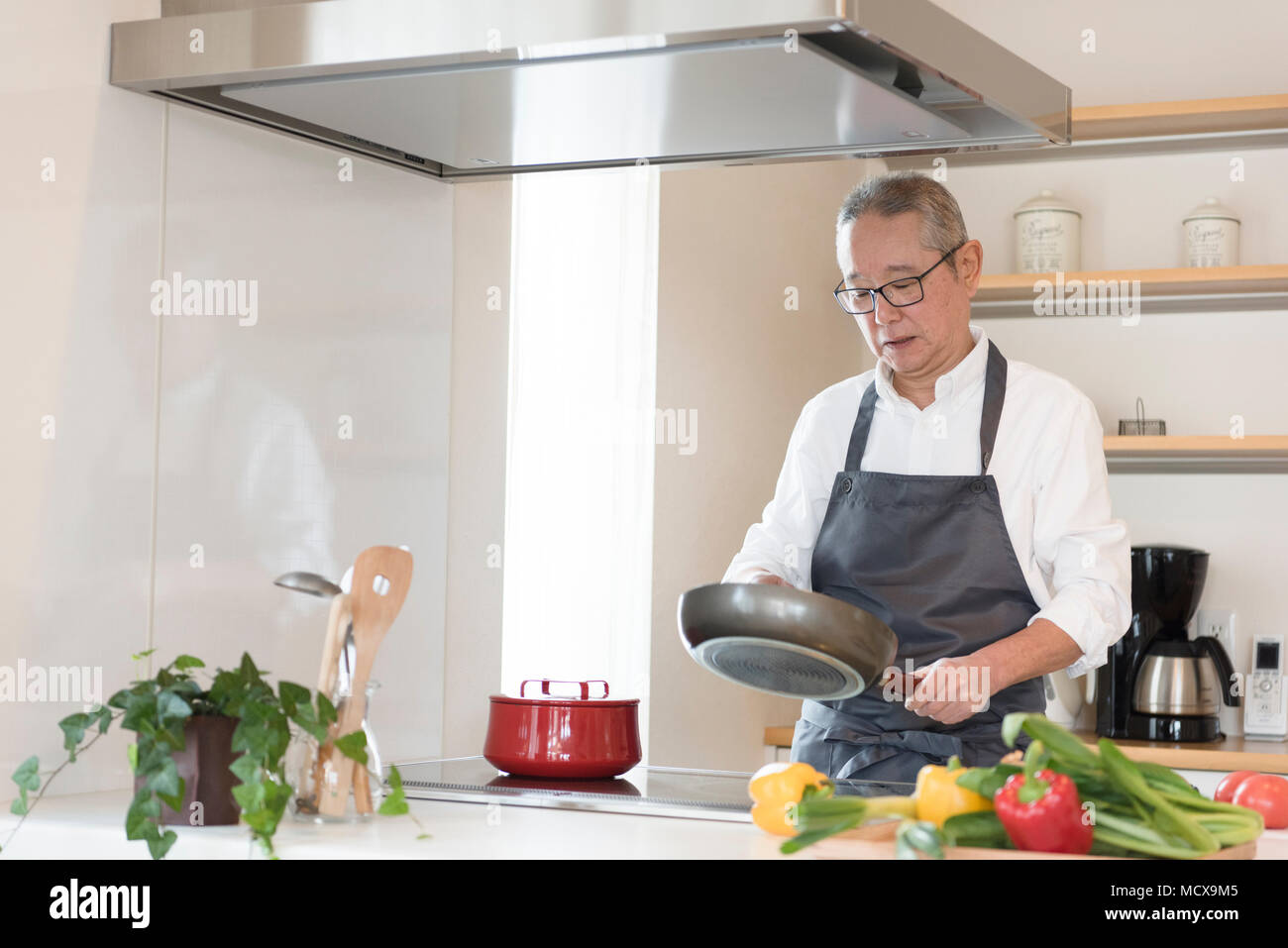 Scene of Senior man cooking Stock Photo - Alamy
