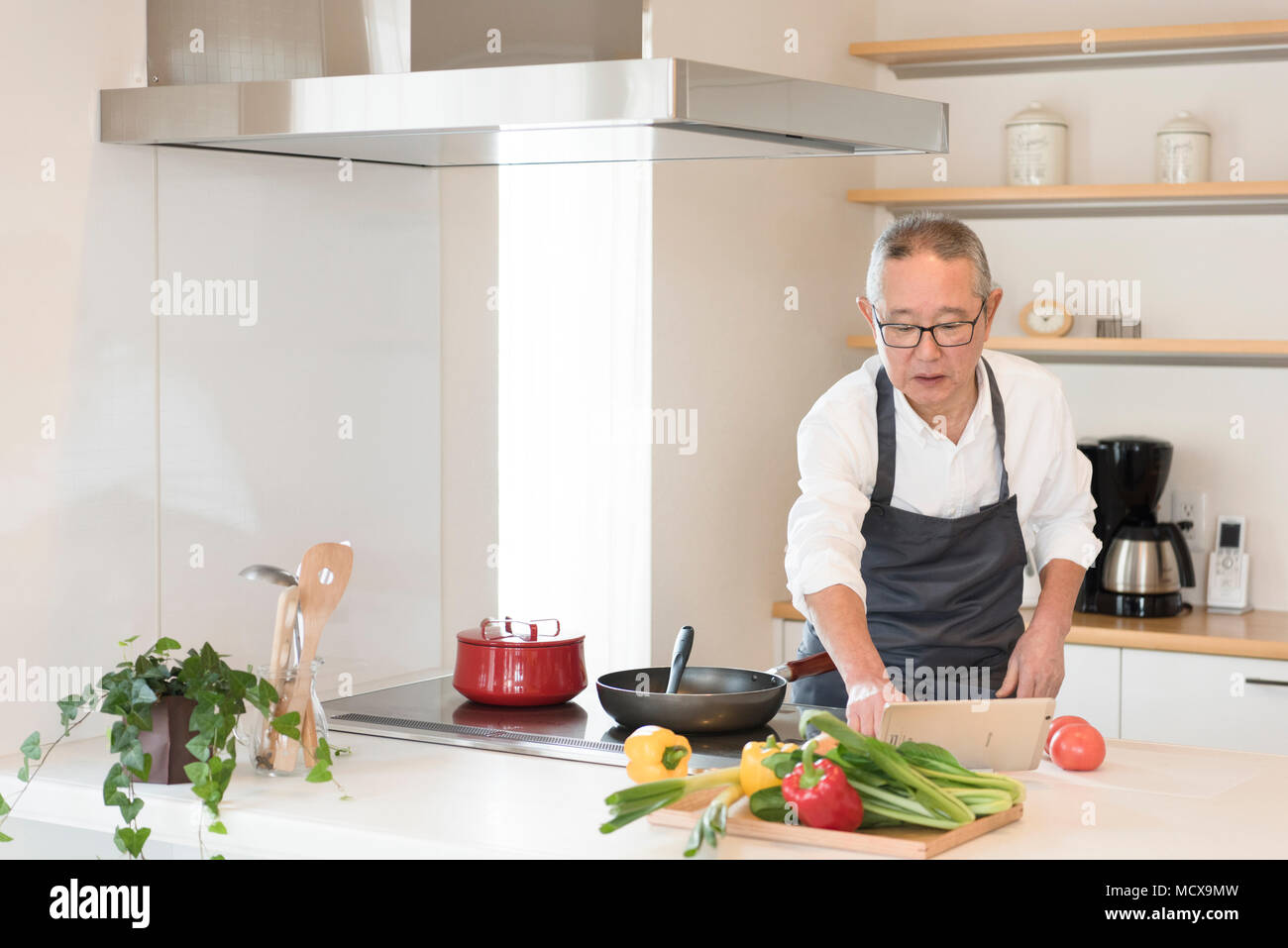 Scene of Senior man cooking Stock Photo - Alamy