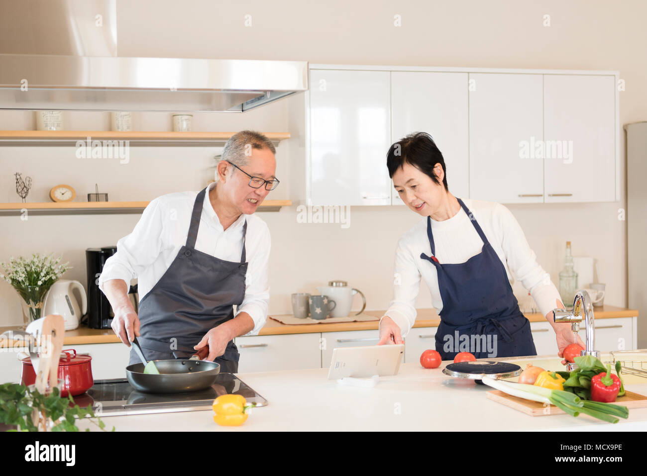 Senior adult japanese woman cooking hi-res stock photography and images ...