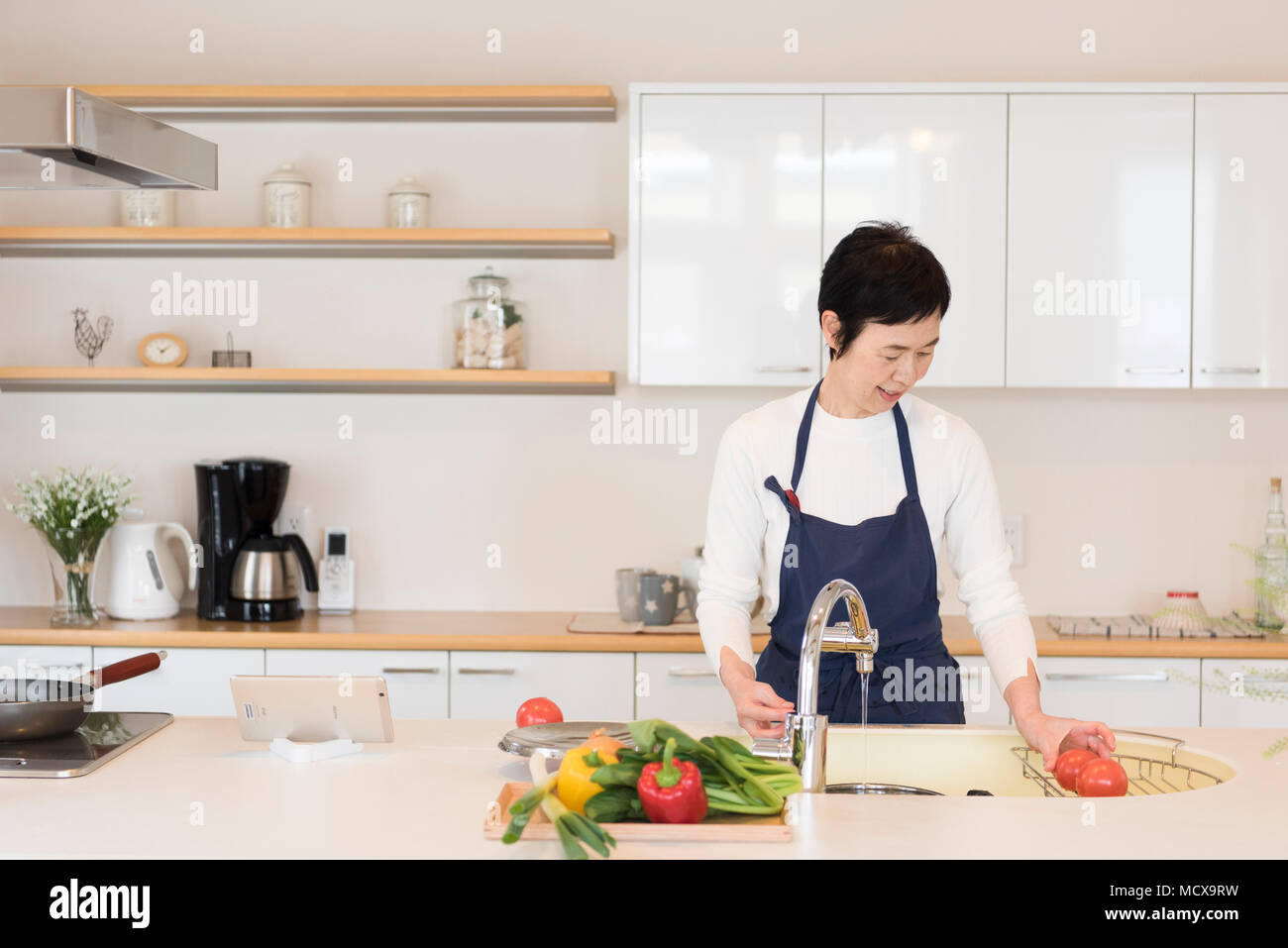 Senior woman cooking Stock Photo - Alamy