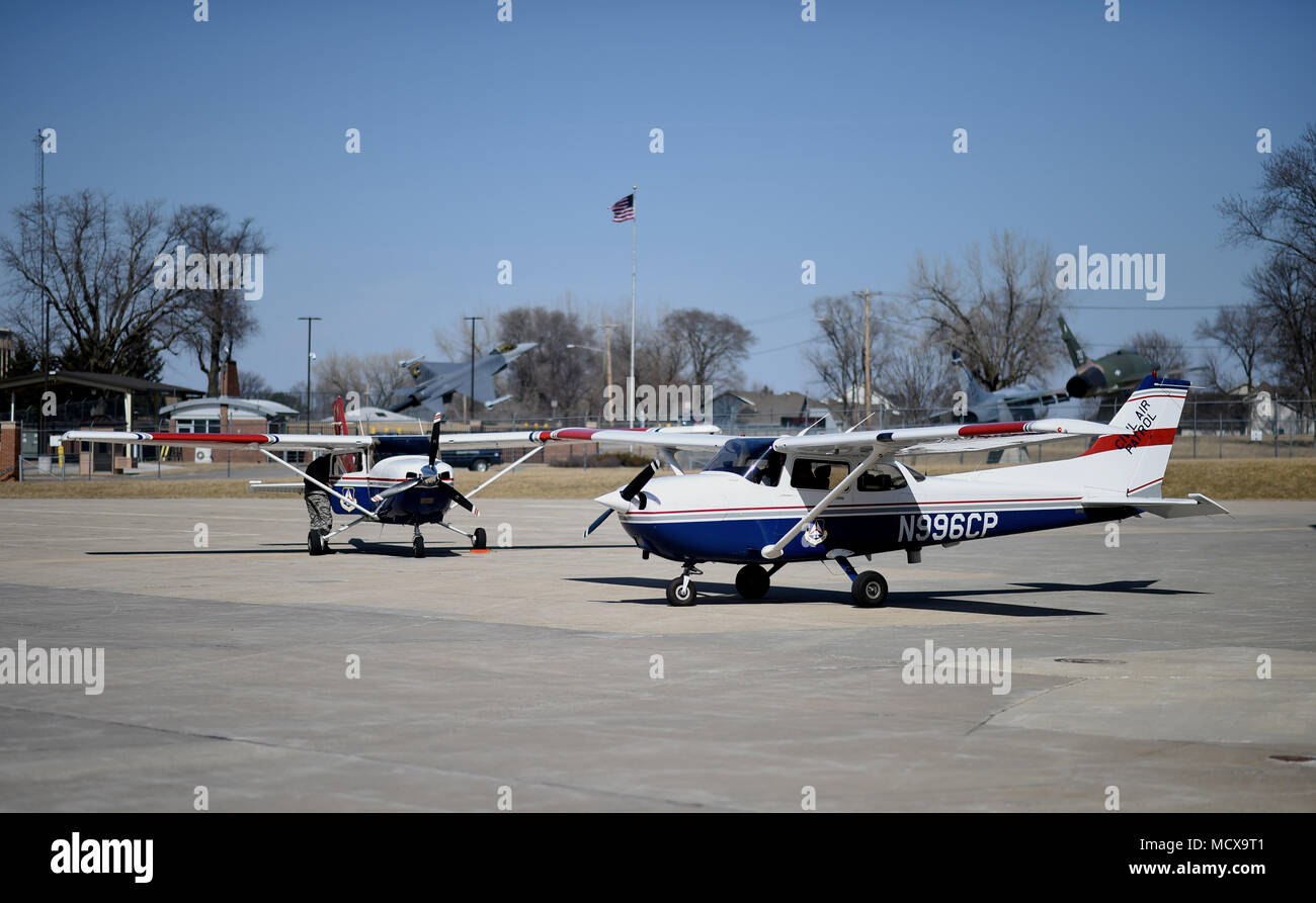 Two Civil Air Patrol Cessna 182 aircraft park on the flight line after ...