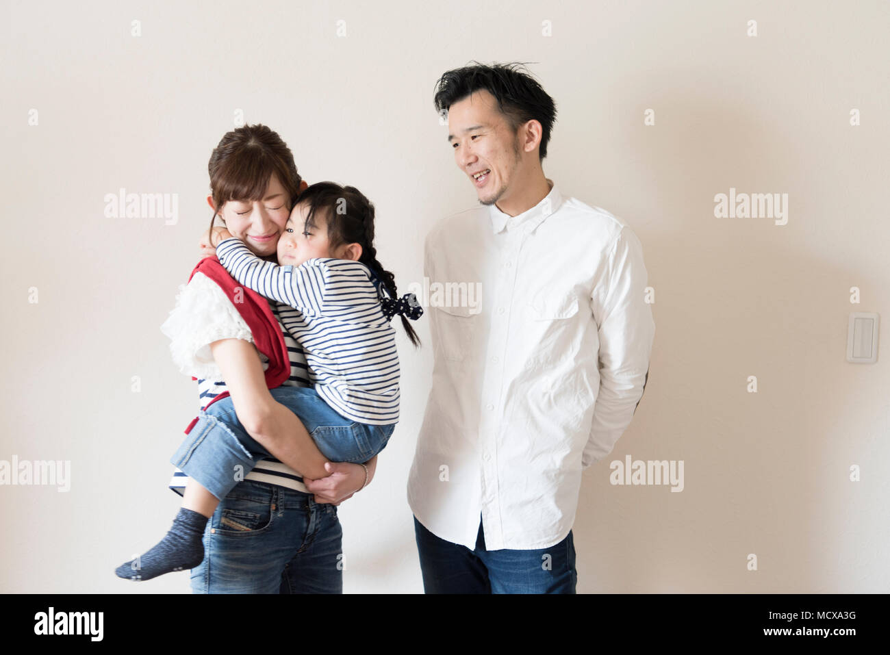Three parents and child Stock Photo - Alamy