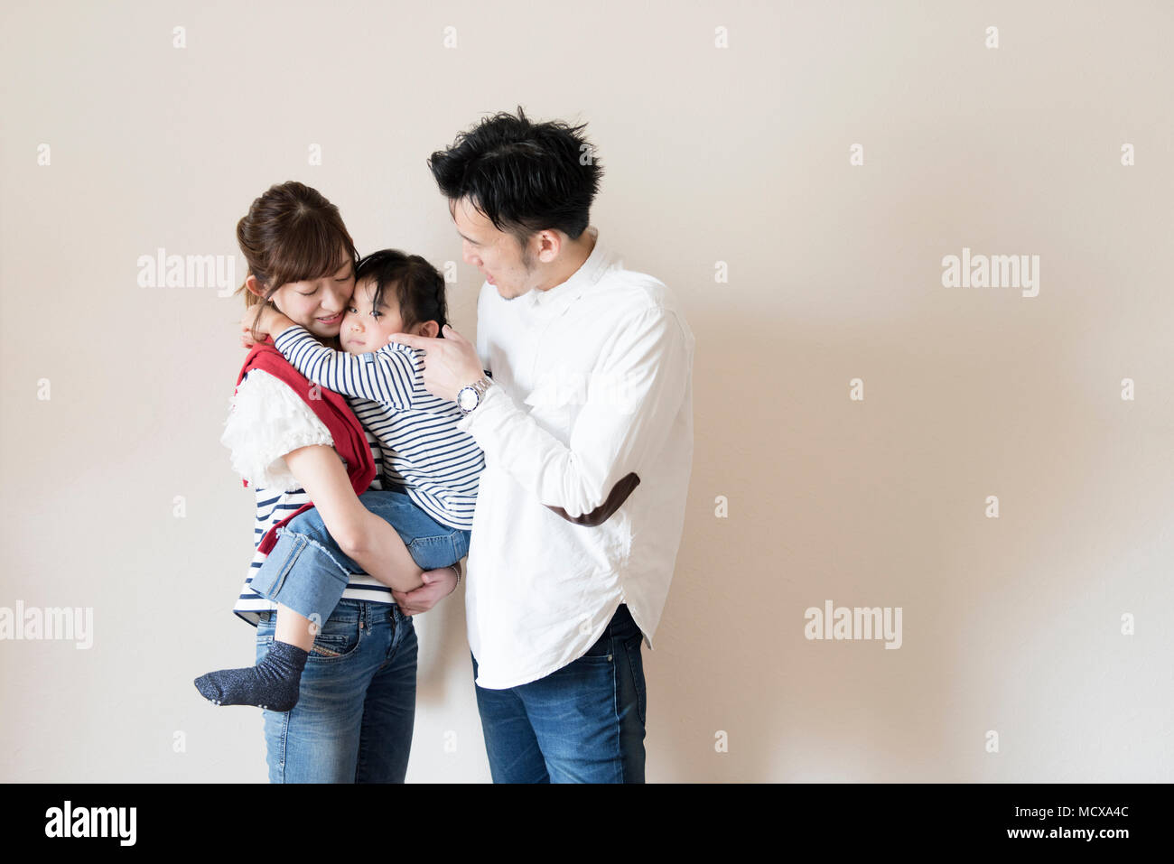Three parents and child Stock Photo - Alamy