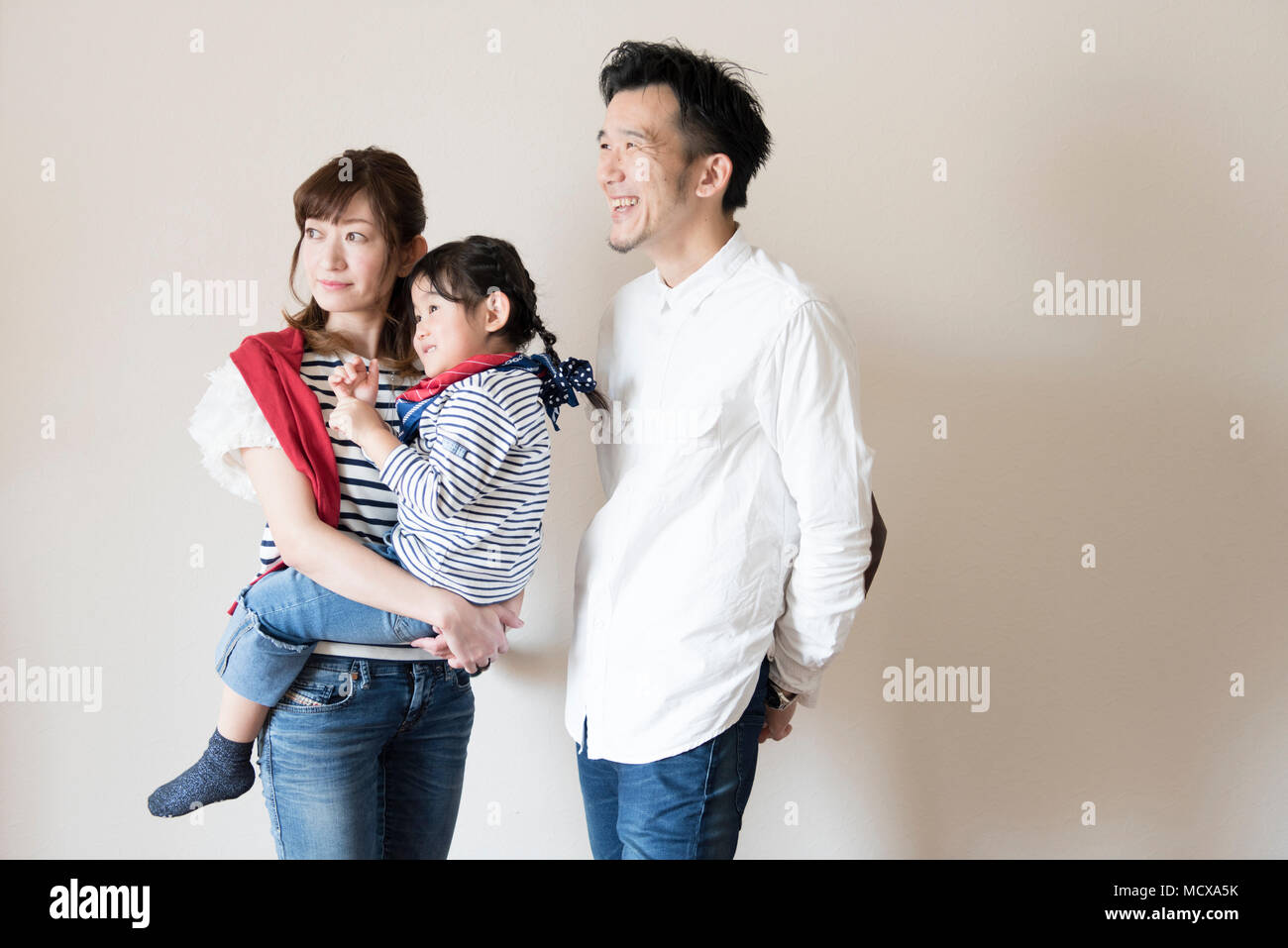 Three parents and child Stock Photo - Alamy