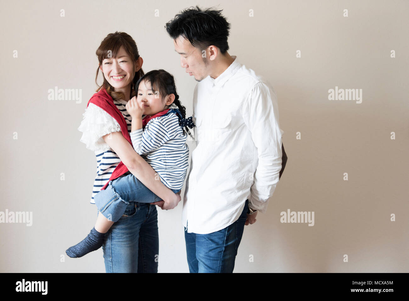 Three parents and child Stock Photo - Alamy