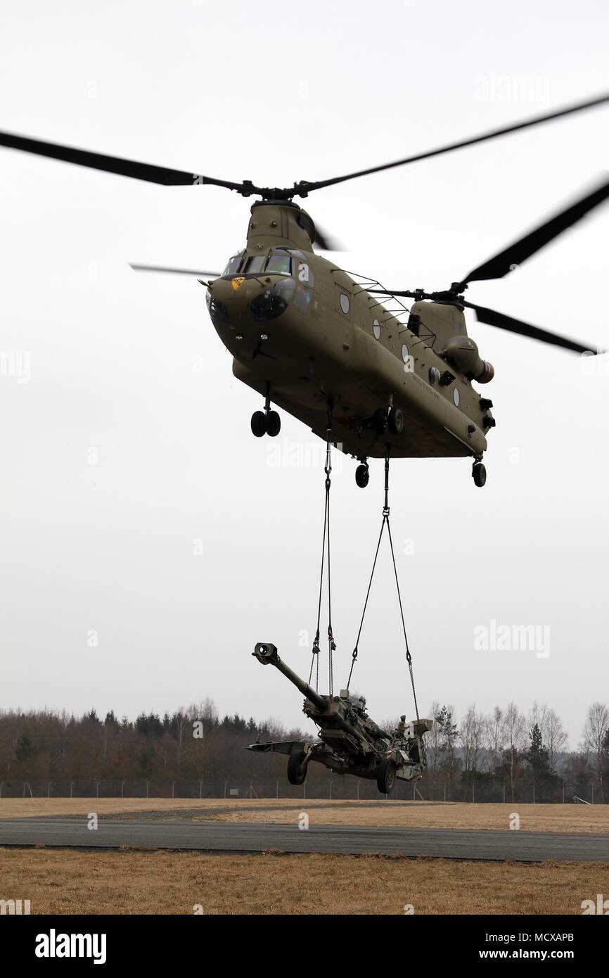 A CH-47 Chinook lifts an M777 howitzer during a sling load operation on March 6 at an air field ...