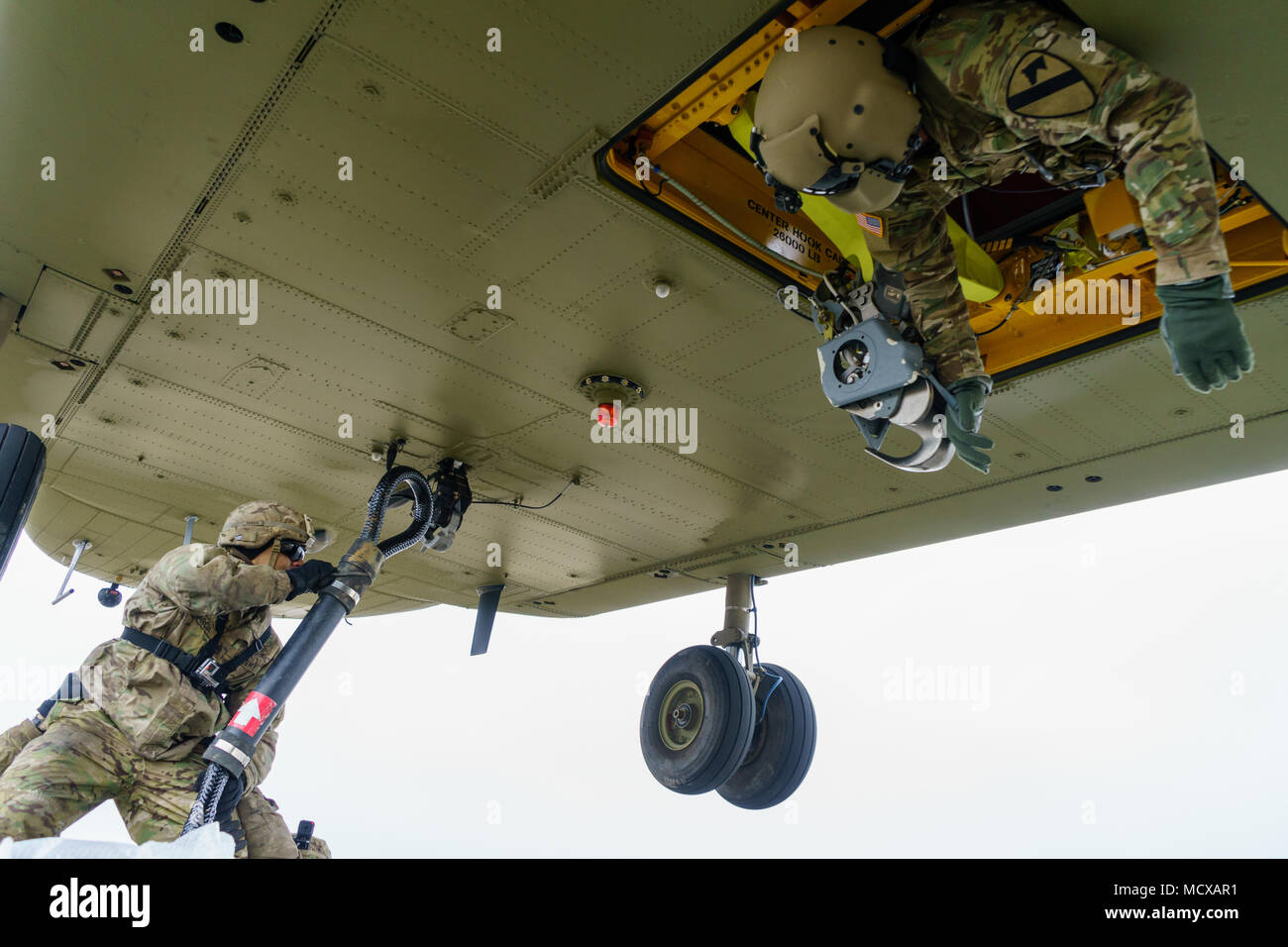 Sgt. 1st Class Kyle Bayless (right), a CH-47 Chinook helicopter ...