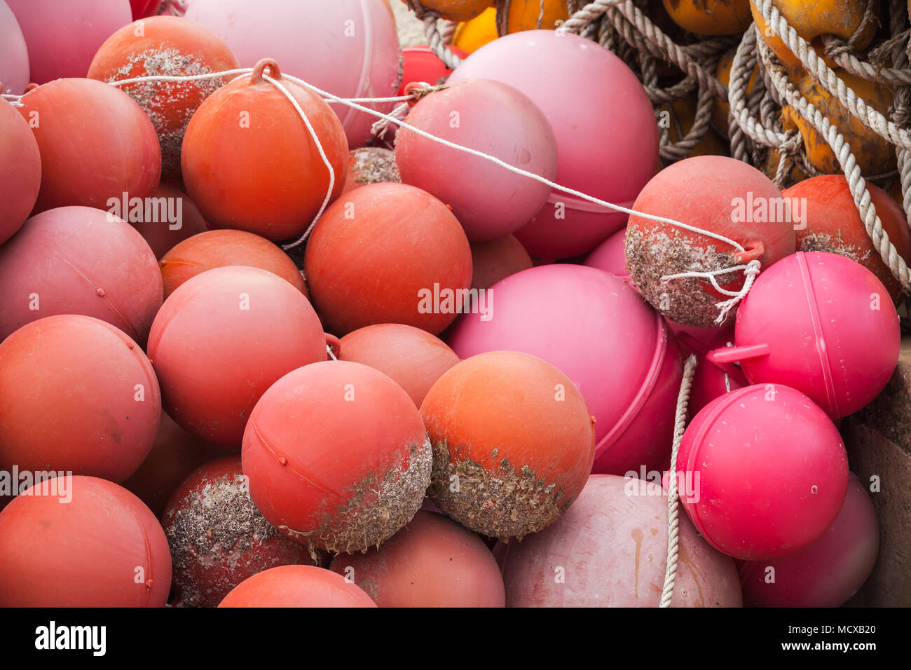 Red spherical plastic floats of fishing nets lay in port Stock Photo ...