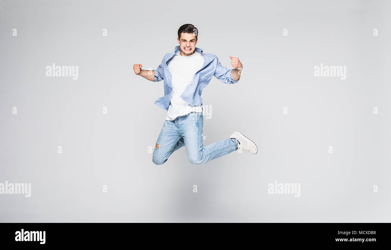 Full-length photo of funny man running or jumping in air isolated over ...