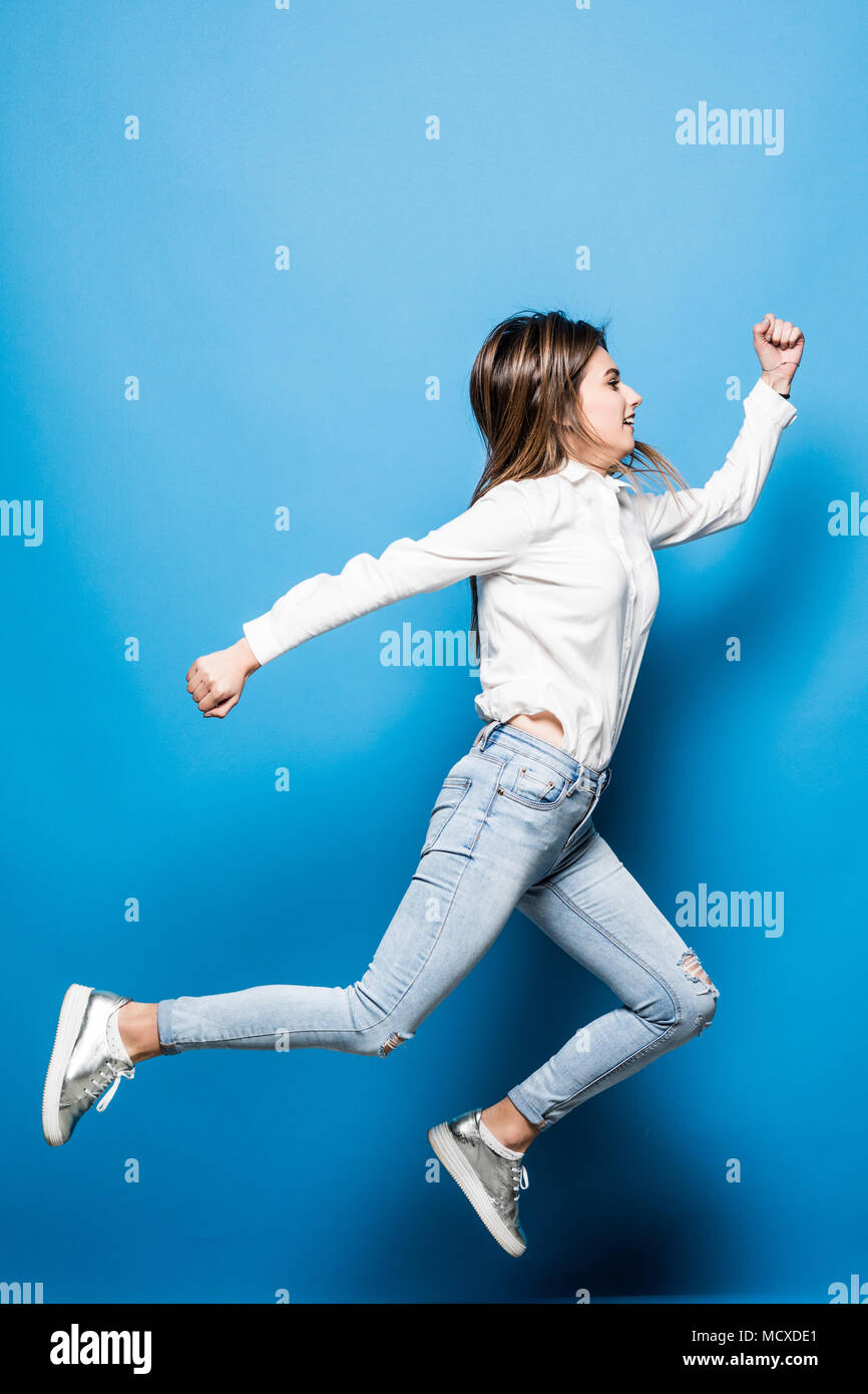 Successful young attractive laughing woman jumping up Stock Photo - Alamy