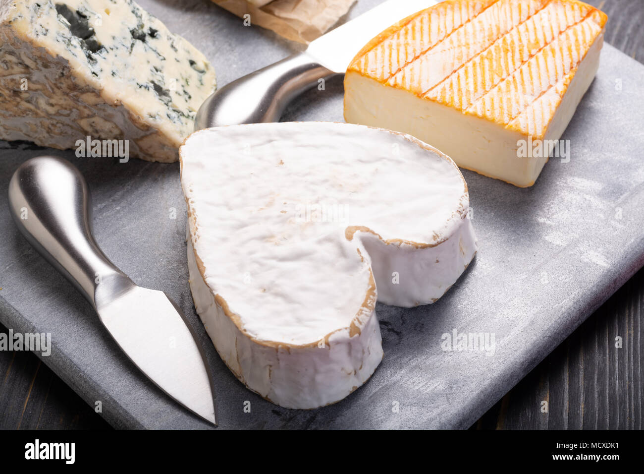 French cheeses plate in assortment, Neufchatel heart shaped aged white ...