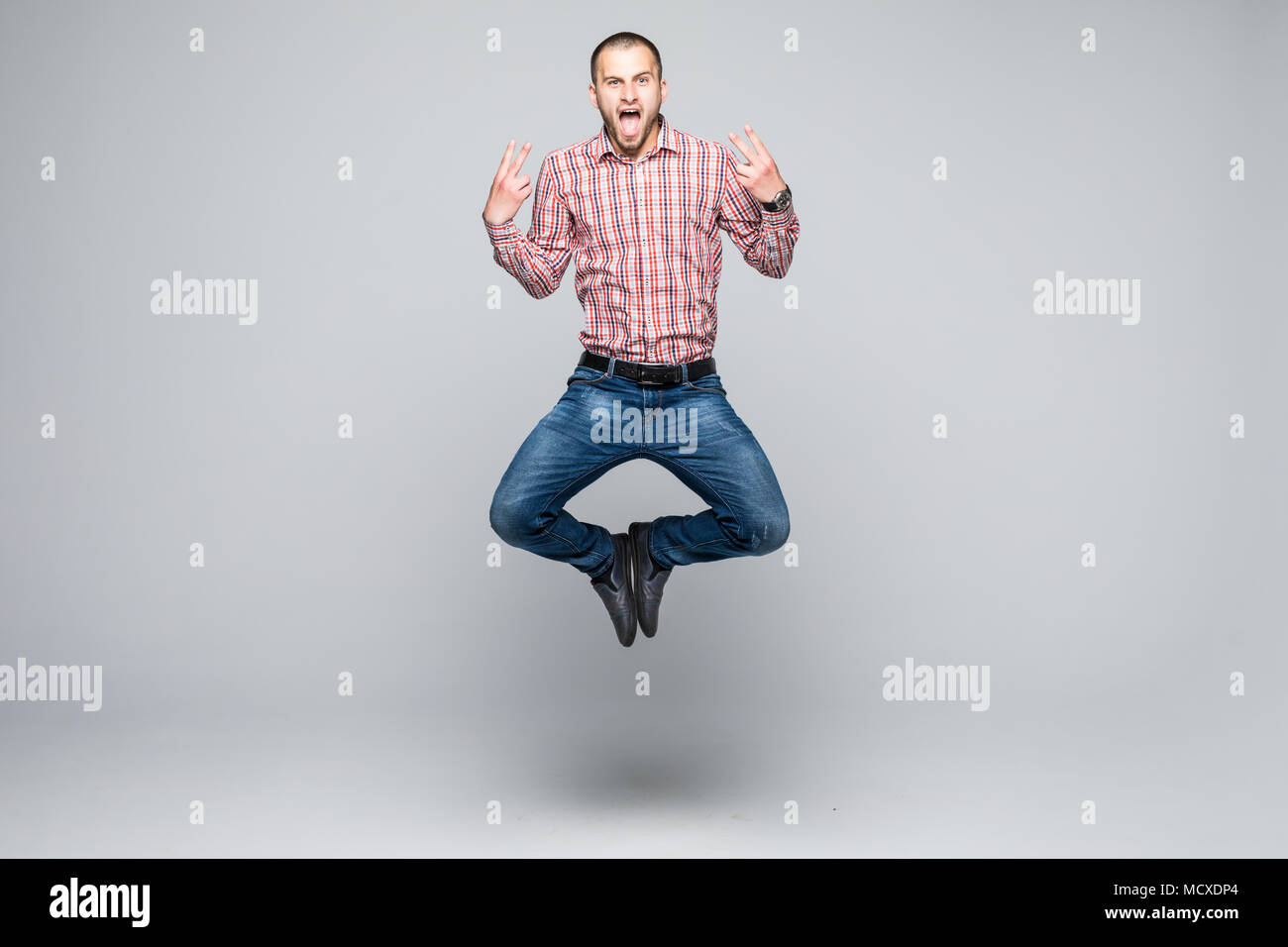 Handsome man jumping isolated on white background Stock Photo - Alamy