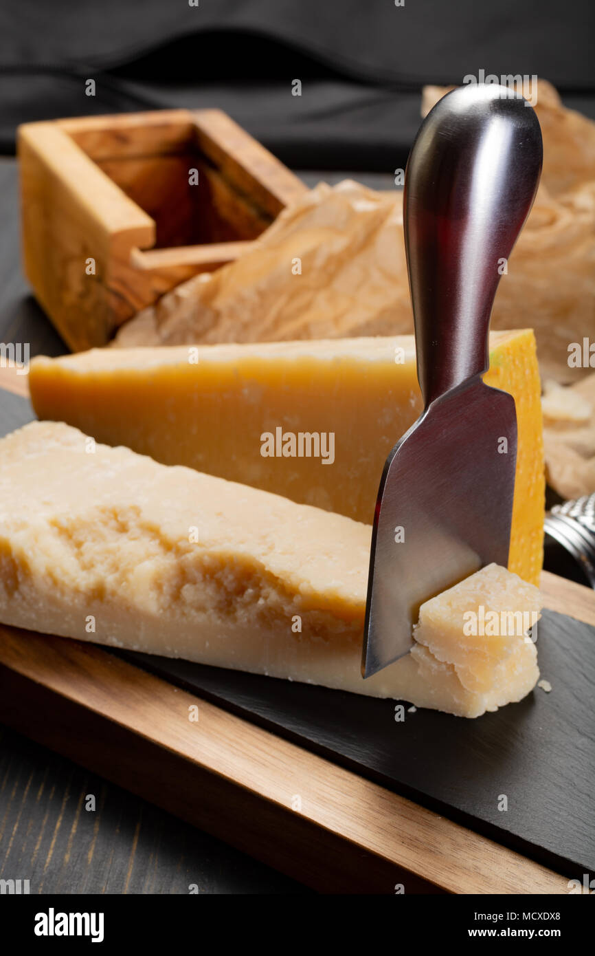 Aged Italian parmesan hard cheese Parmigiano-Reggiano with cheese knife ...