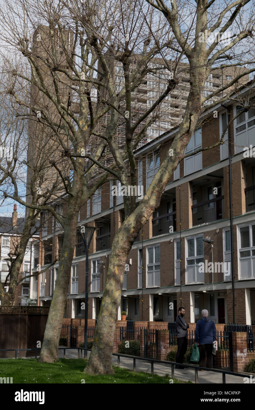 Neighbours talking in the street with a view of the 26-storey Balfron ...