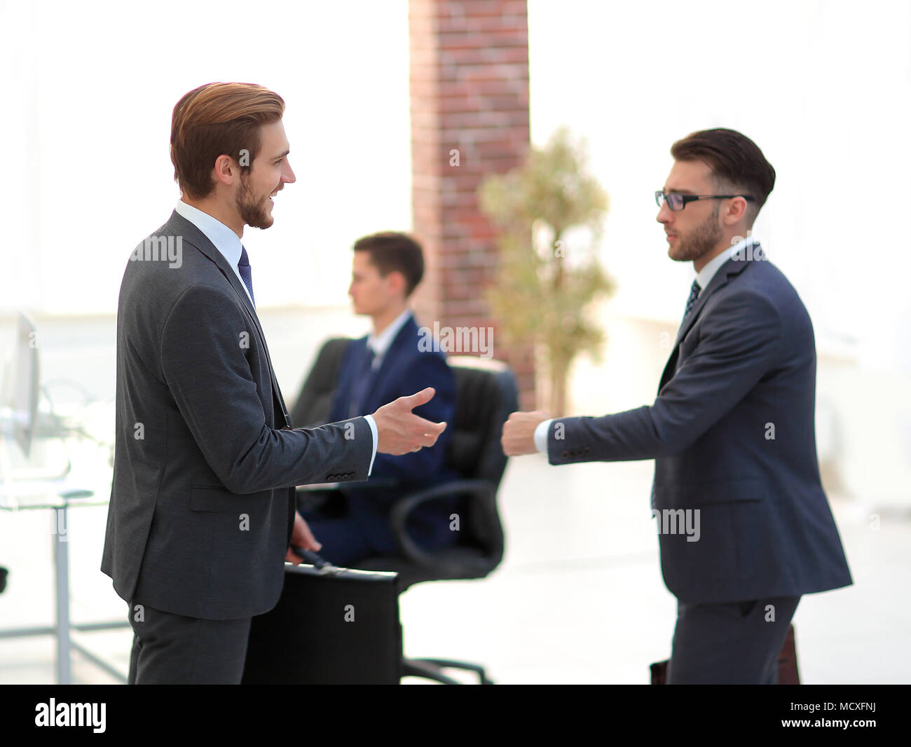 Two employees in business suits work in a conference hall Stock Photo ...