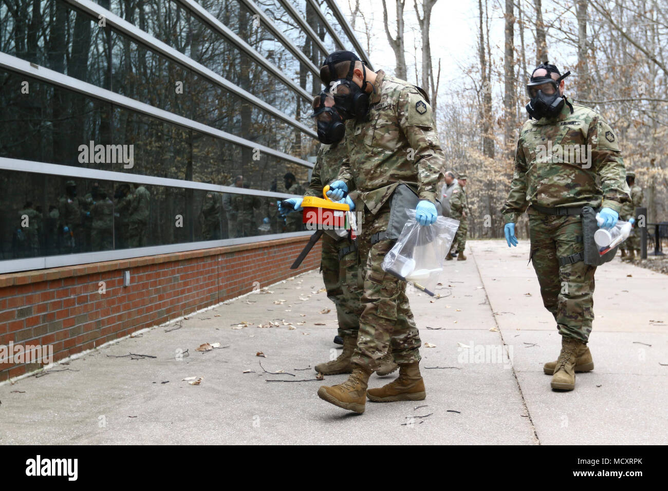 Specialist Charles Babcock (front center), a sampling team leader for ...