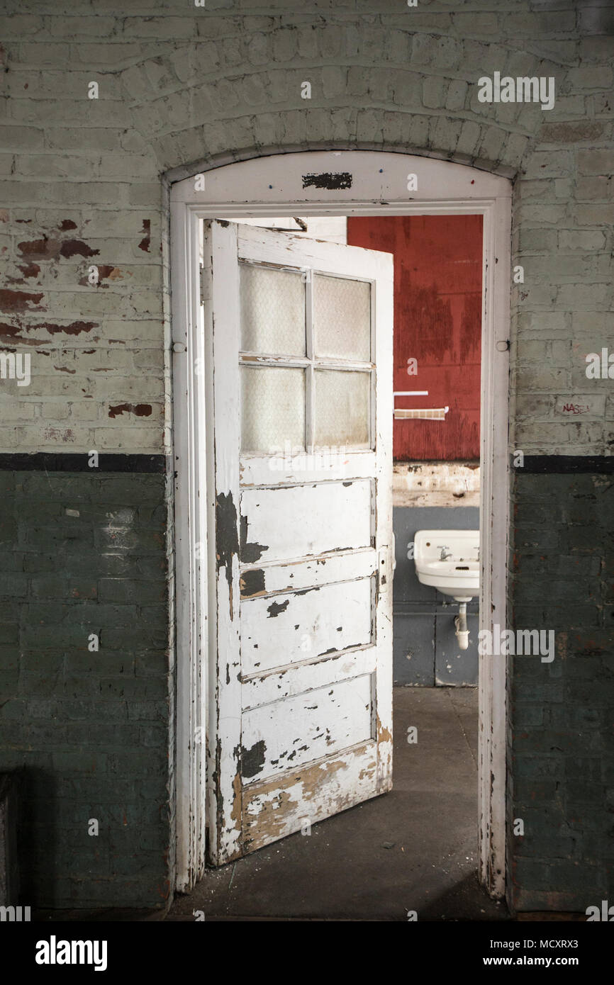 An old door to a rest room in an old factory Stock Photo - Alamy