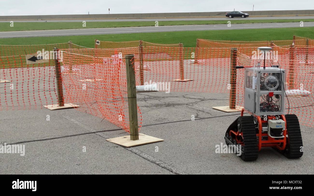 A student-built robot takes on the obstacle course as part of the final ...