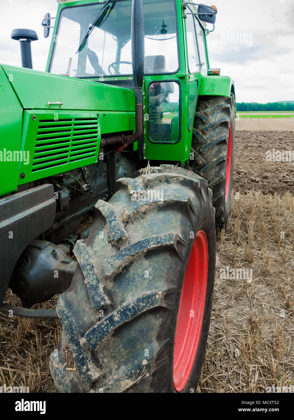 Tractor on field Stock Photo - Alamy