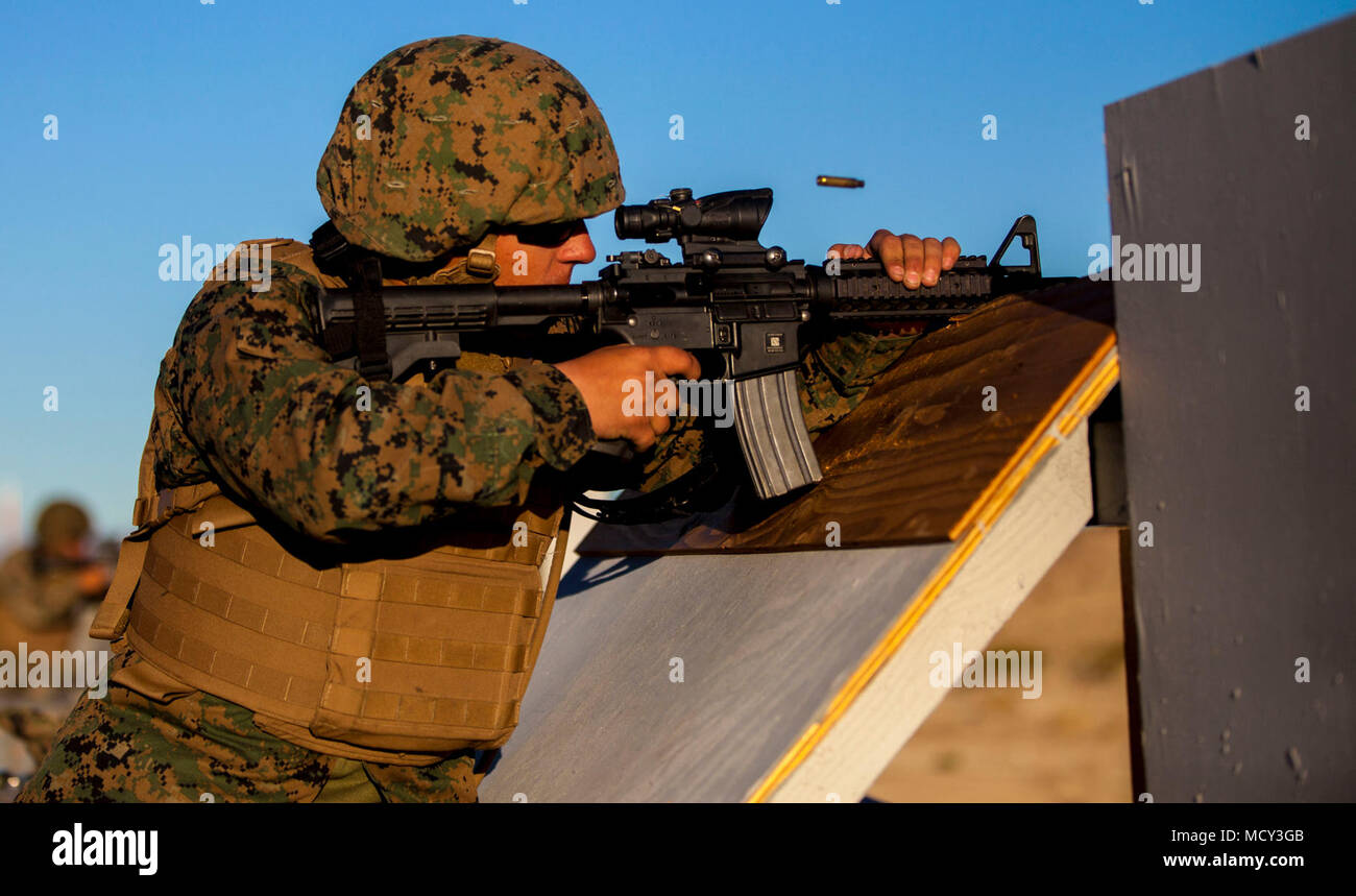 A Marine with Alpha Company, Headquarters Battalion, shoots an M4 ...