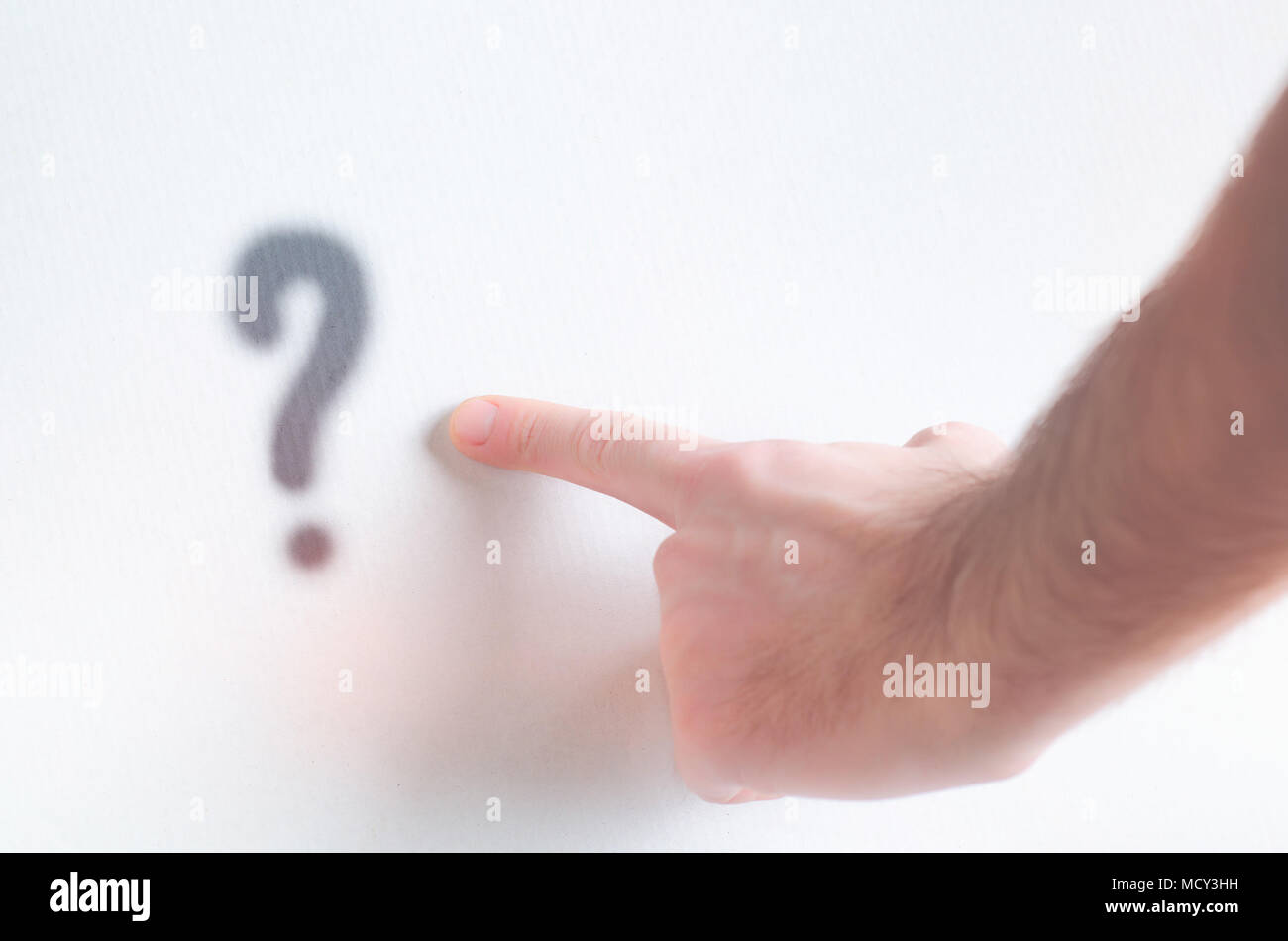 Finger pointing to question mark concept Stock Photo - Alamy