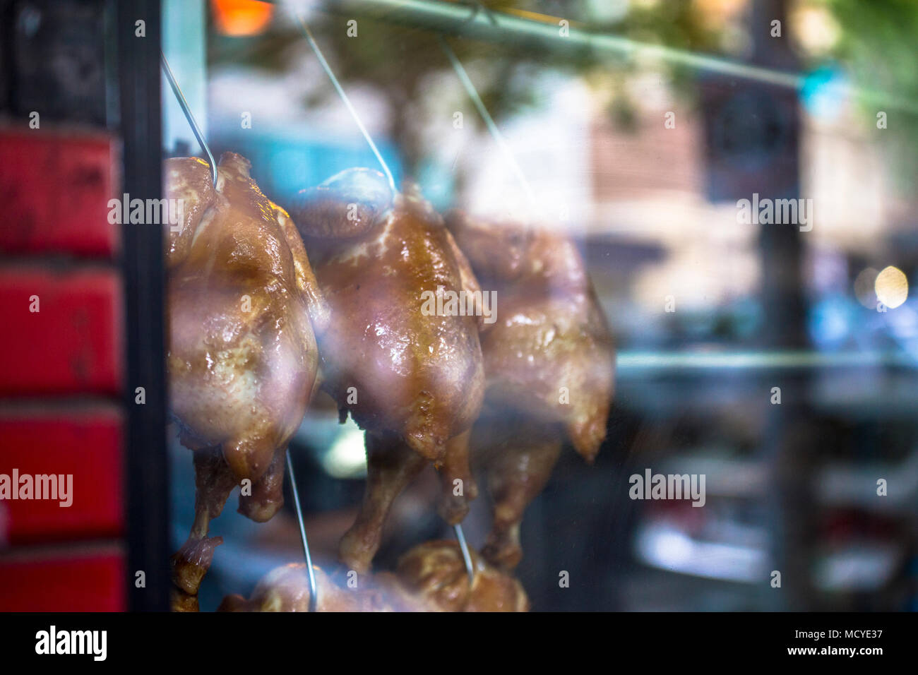 Roast chicken hanging behind glass window in chinatown Melbourne city ...