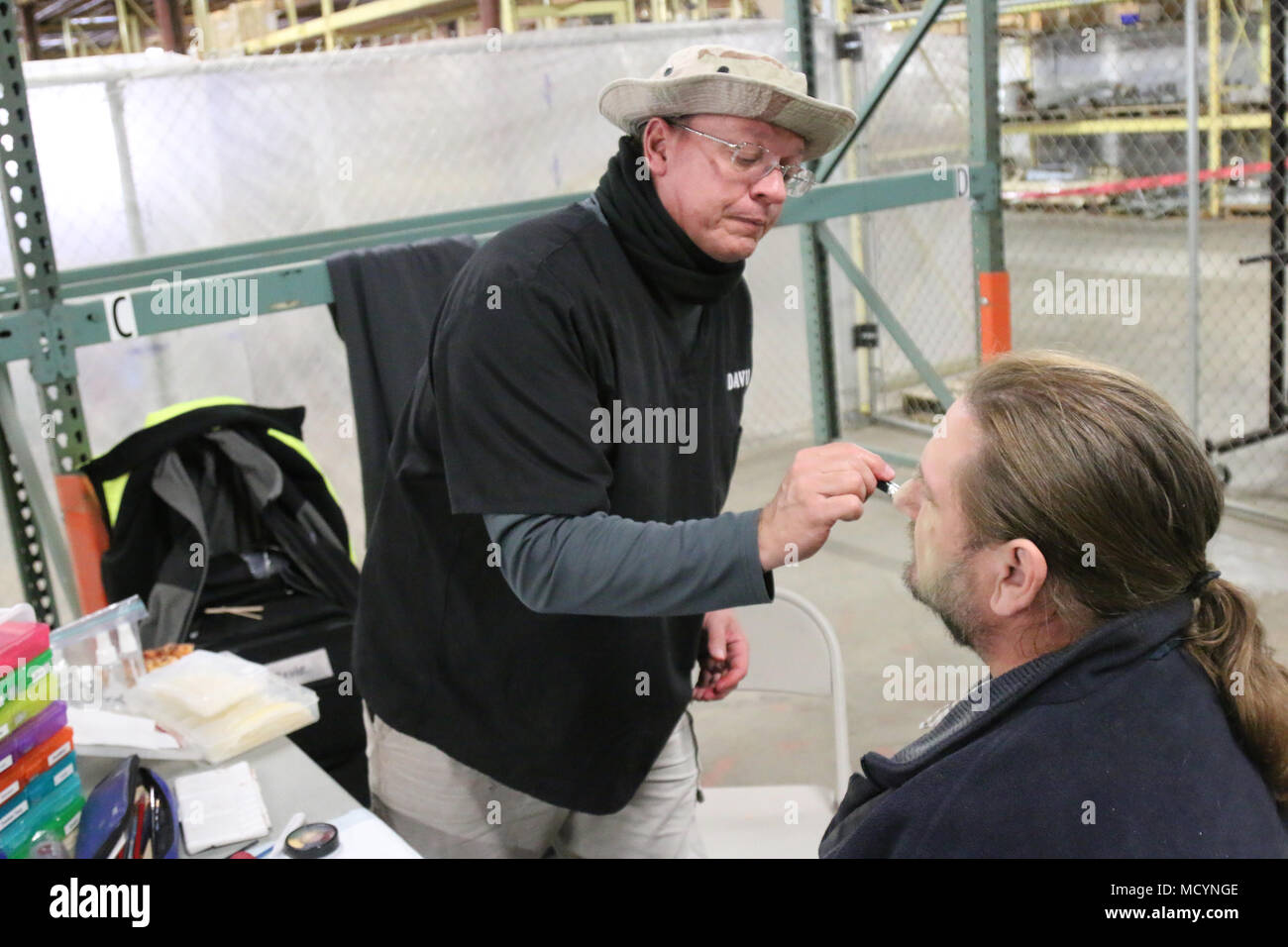 David Steele puts makeup on a volunteer mock casualty during a mock ...