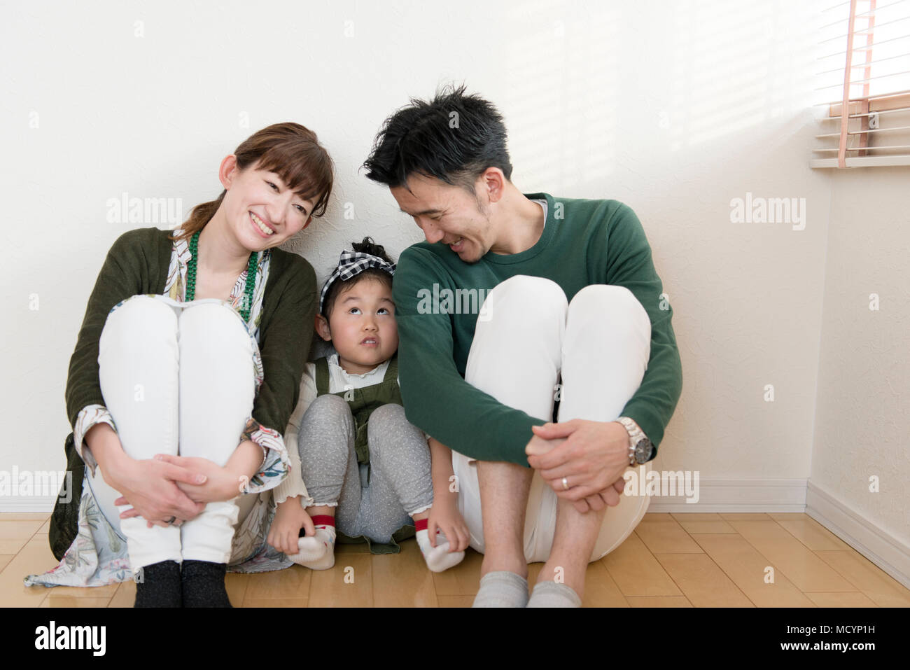 Three close parents and child Stock Photo - Alamy