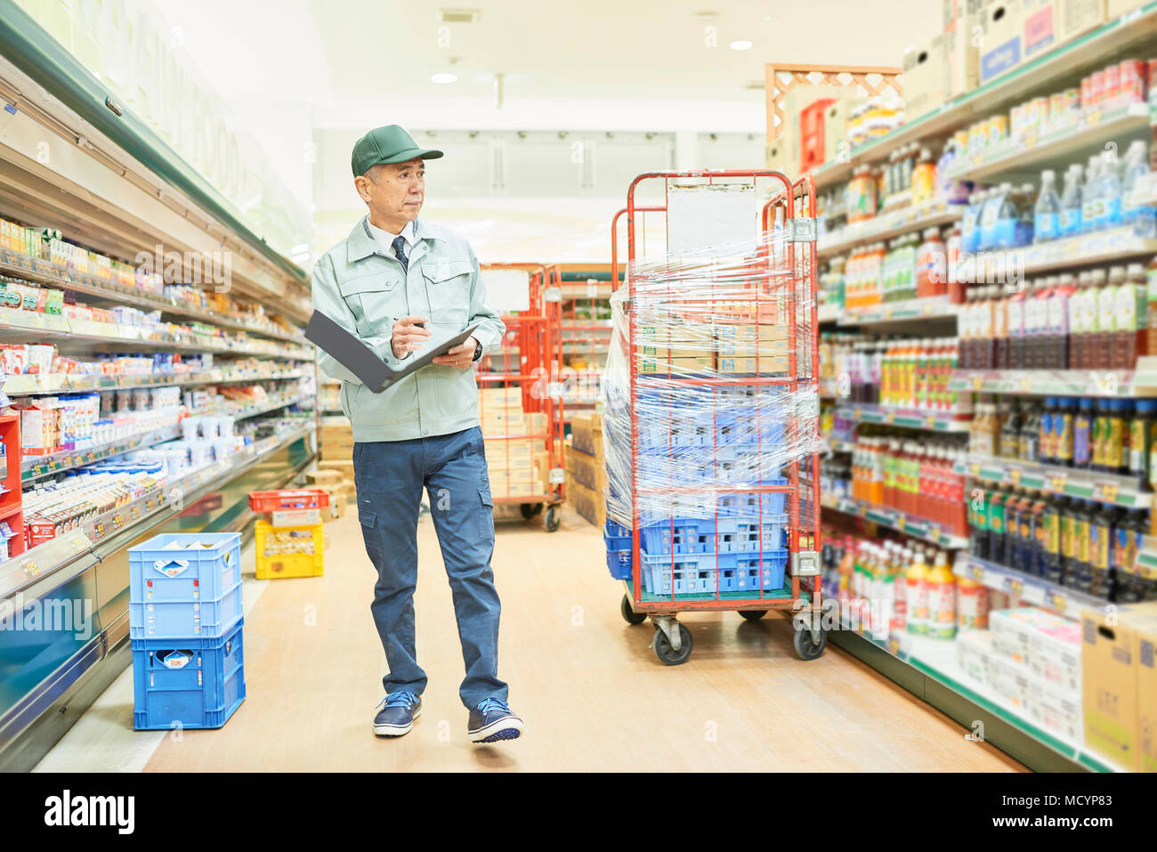 Senior man manager in supermarket (stock control Stock Photo - Alamy