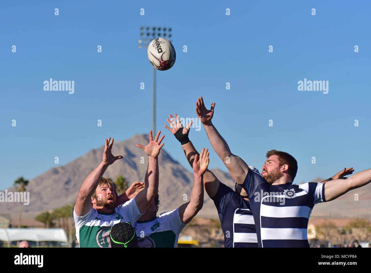 Coast Guard men’s rugby team members reach for a line out during a ...