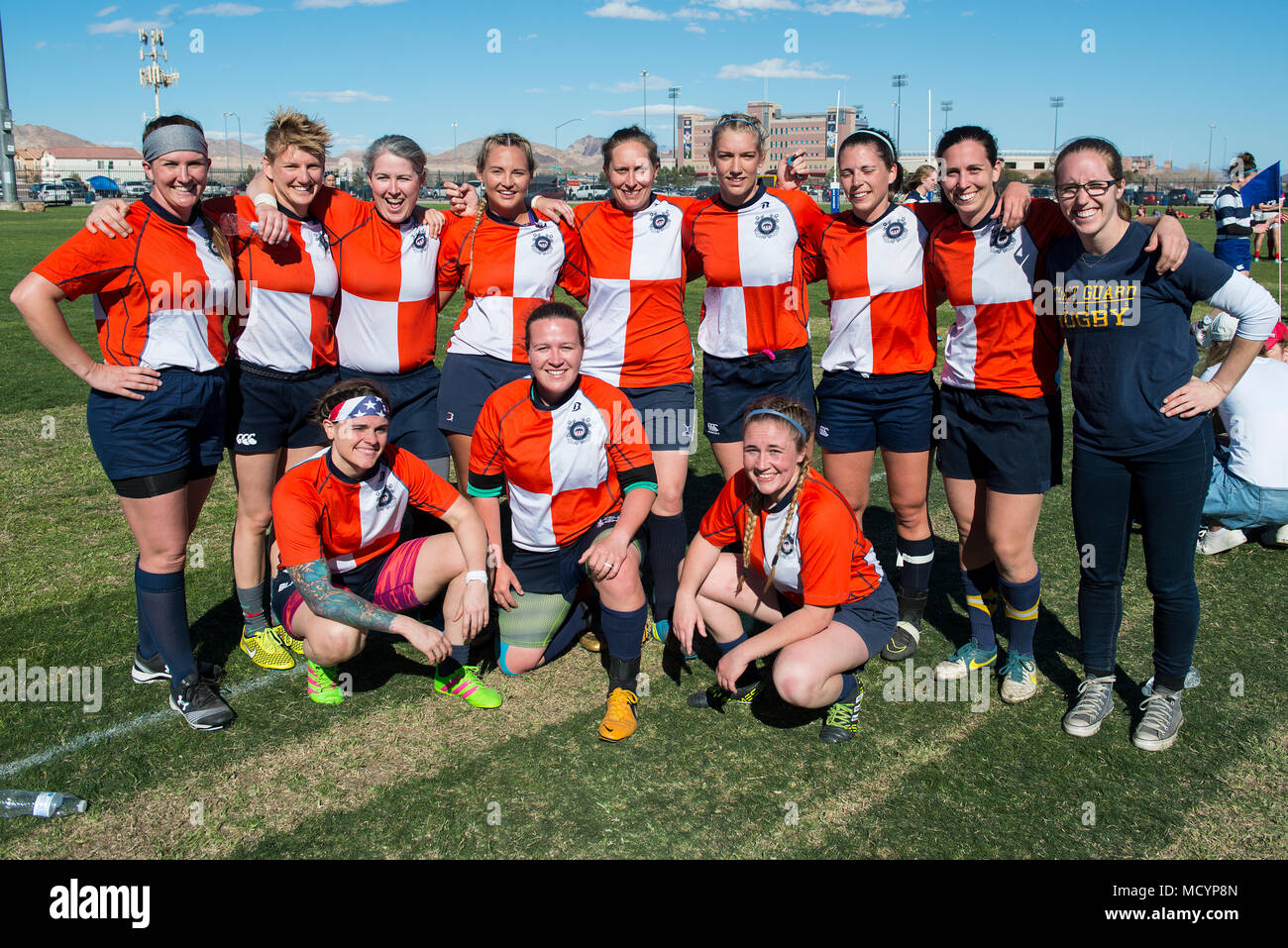 The Coast Guard women’s rugby team poses together after finishing the ...